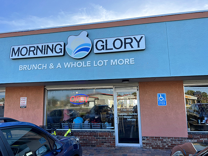 Morning Glory's cheerful blue exterior promises breakfast salvation for hungry beachgoers. The "Brunch & A Whole Lot More" tagline isn't just marketing&mdash;it's a delicious prophecy.