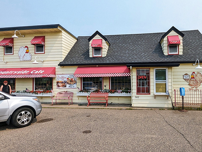 The iconic chicken mascot stands guard atop this cheerful yellow building, promising breakfast salvation to all who enter.