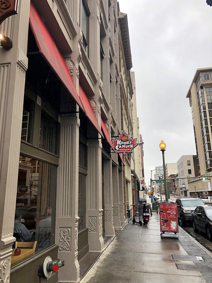 The iconic maple leaf sign beckons hungry adventurers to Kooky Canuck, where Canadian charm meets Memphis hospitality on downtown's bustling streets.