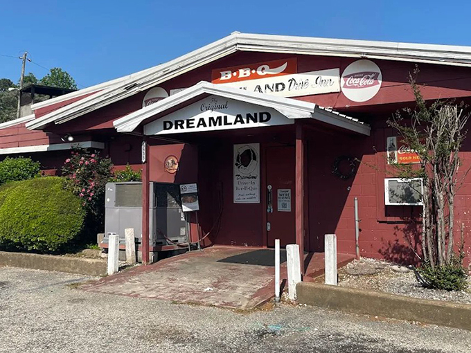 The unassuming red exterior of Dreamland BBQ stands like a barbecue beacon in Tuscaloosa. No fancy frills needed when what's inside speaks volumes through smoke signals.