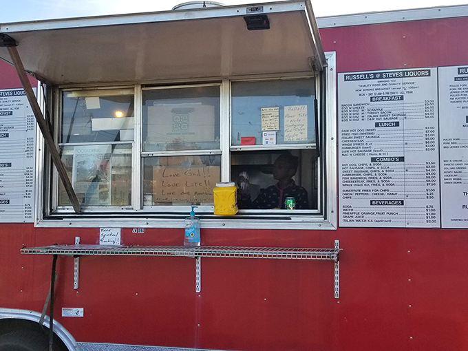 The bright red food truck stands like a culinary lighthouse in the parking lot, beckoning hungry souls with promises of smoky delights.