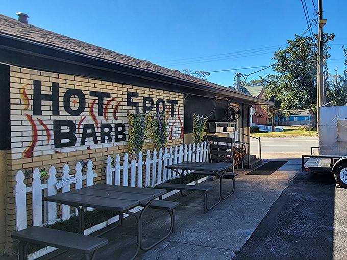 The unassuming exterior of Hot Spot Barbecue proves once again that the best barbecue joints often hide behind modest facades. Those yellow umbrellas practically whisper, "Smoke signals ahead!"