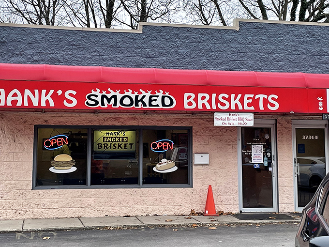 The bright red awning of Hank's stands out like a beacon for barbecue pilgrims, promising smoky salvation inside this unassuming Indianapolis treasure.