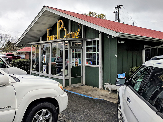 The iconic red roof and vintage sign of Red Bridges Barbecue Lodge stand as a beacon for hungry travelers. This Shelby landmark has been calling barbecue pilgrims home since 1946.