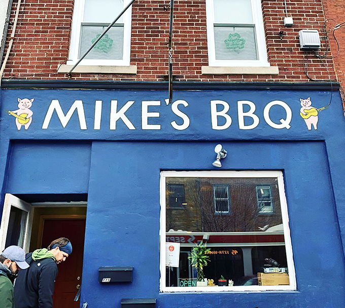 The blue storefront with cartoon pigs playing banjos isn't just cute &ndash; it's a beacon of smoky promise in South Philly's culinary landscape.