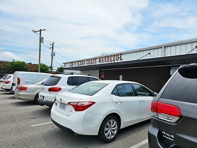 The rusted metal sign hanging above ZZQ's entrance isn't just decoration&mdash;it's a promise of authentic Texas flavor waiting just beyond those wooden picnic tables.