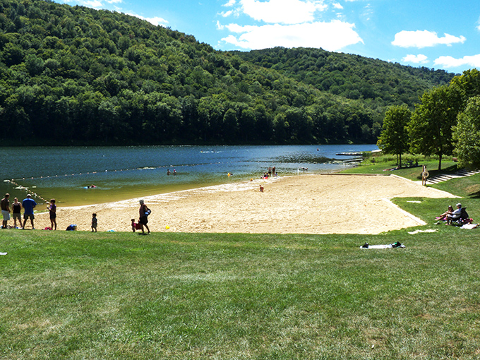 Golden sands meet crystal waters beneath an emerald mountain backdrop. Pennsylvania's secret beach paradise offers a coastal experience hundreds of miles from any ocean.
