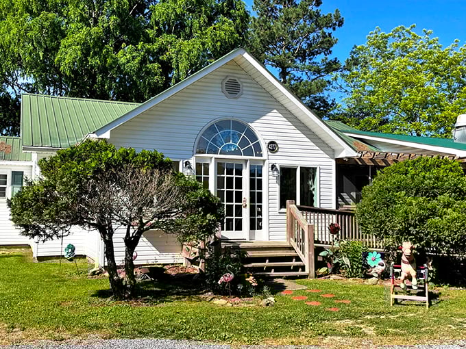 A storybook cottage come to life, The Hatter Cafe's charming exterior welcomes you with a wooden porch, colorful flowers, and the promise of culinary adventures.