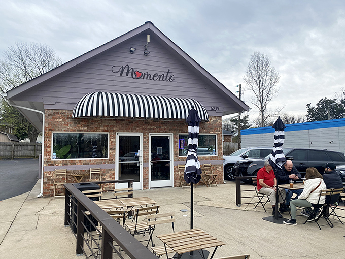 A brick cottage with a striped awning that whispers, "Come inside, we've got something special brewing." This charming exterior hides Tennessee's best-kept breakfast secret.