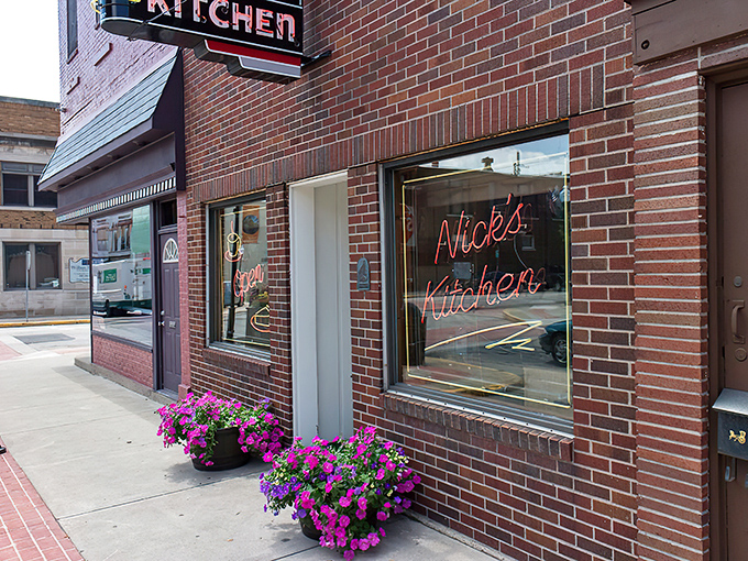The brick-red corner building stands like a sentinel of satisfaction, promising comfort food treasures within its unpretentious walls.