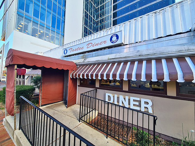 The stainless steel exterior of Tastee Diner stands defiant against time, its red and white awning a beacon for breakfast pilgrims seeking authenticity in Bethesda.