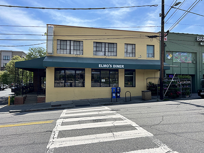 The unassuming yellow exterior of Elmo's Diner stands like a beacon of breakfast hope on Durham's Ninth Street, promising comfort within its walls.