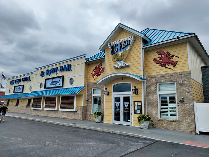 The cheerful yellow exterior of Big Fish Grill stands like a beacon for seafood lovers, promising maritime delights within its nautical-themed walls.