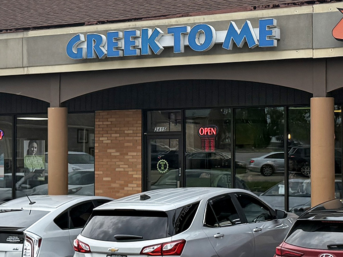 The bright blue sign beckons like a Mediterranean lighthouse in a sea of strip mall sameness. Kentucky's answer to Athens awaits inside.