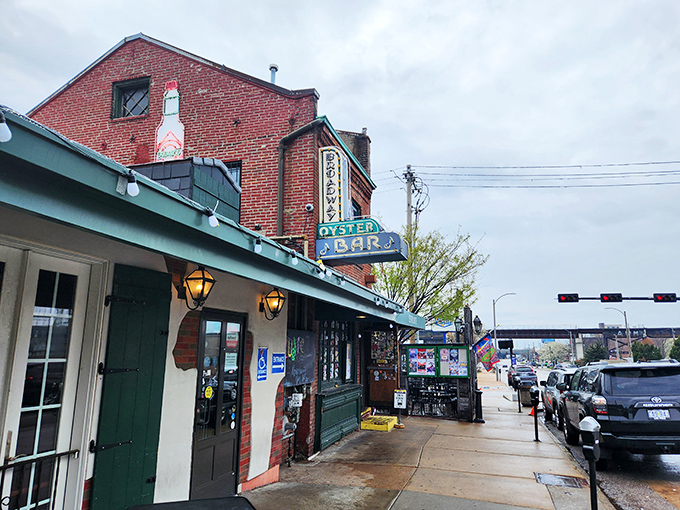 The historic brick facade of Broadway Oyster Bar welcomes seafood lovers with its vibrant green awning and door plastered with memories of good times past.