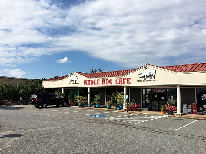 The promise of BBQ bliss beckons from this unassuming storefront. Whole Hog's iconic red sign stands like a carnivore's North Star against Arkansas skies.