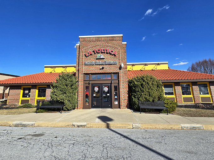 La Tolteca's sunny yellow exterior with terracotta roof stands like a beacon of culinary promise against Delaware's sky. No architectural awards here&mdash;just the promise of authentic flavors inside.