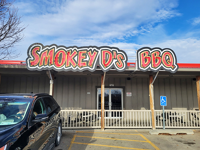 The unassuming exterior of Smokey D's BBQ, where the parking lot's always full and that heavenly smoke aroma greets you before the door does.