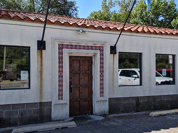 Three flags flutter proudly outside this unassuming barbecue sanctuary, where the red tile roof and stucco walls hide smoky treasures within.