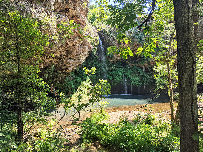Nature's perfect curtain call &ndash; water cascades over a wide ledge, creating a serene backdrop that makes even smartphone photographers look like Ansel Adams.