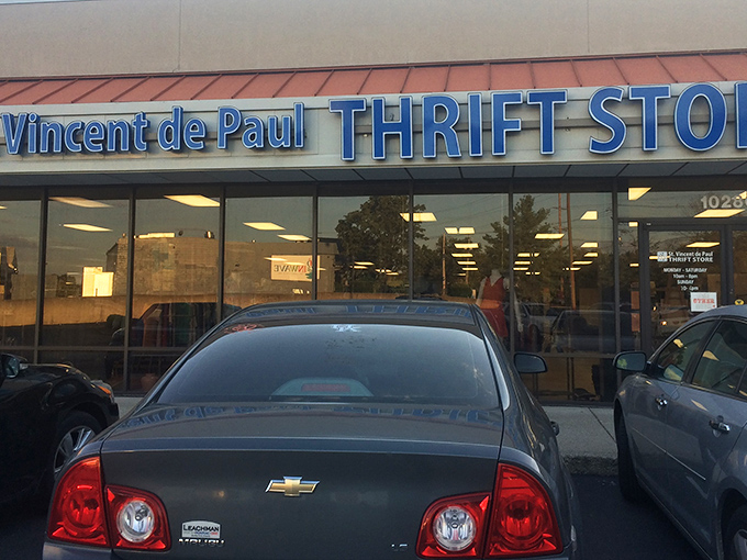 The blue signage of St. Vincent de Paul beckons like a thrift store lighthouse, promising treasures within those glass doors.