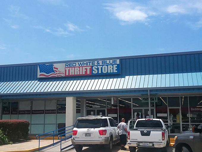 The patriotic facade of Red White & Blue Thrift Store stands like a treasure chest waiting to be opened, promising adventures in secondhand splendor under the Louisiana sun.  