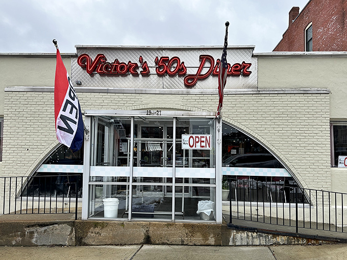 The classic white brick exterior of Victor's 50's Diner stands like a time capsule in Hudson, complete with that iconic red neon sign beckoning hungry travelers.