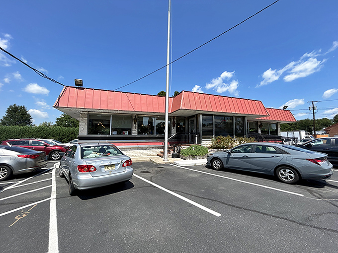 The iconic red roof of Route 1 Diner stands as a beacon to hungry travelers, promising comfort food and Jersey hospitality just off the highway.