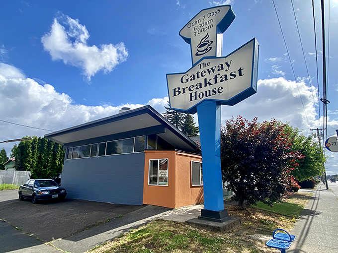 The iconic blue and white arrow sign stands like a beacon of breakfast hope against Portland's famously fickle sky. Classic Americana at its finest.