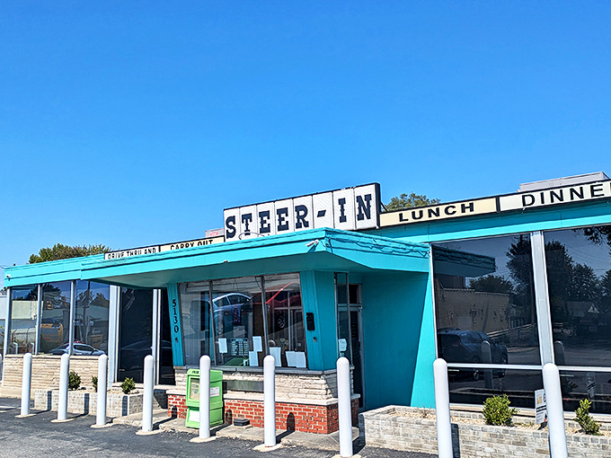 The turquoise beacon of Steer-In stands proudly against an Indiana sky, promising comfort food salvation to hungry Indianapolis souls.