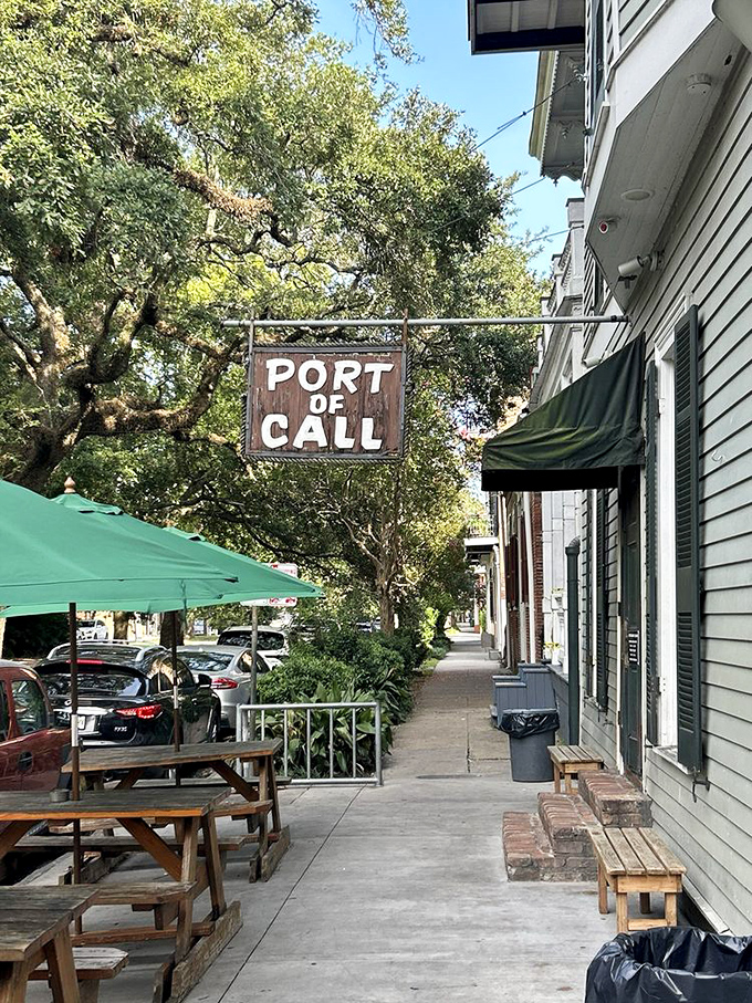 The unassuming exterior hides culinary greatness, with Port of Call's wooden sign swinging gently like a maritime invitation to burger paradise.