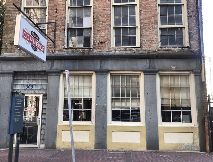 The iconic red awning of Majoria's Commerce Restaurant stands out against historic brick, a beacon for breakfast pilgrims in New Orleans' CBD.