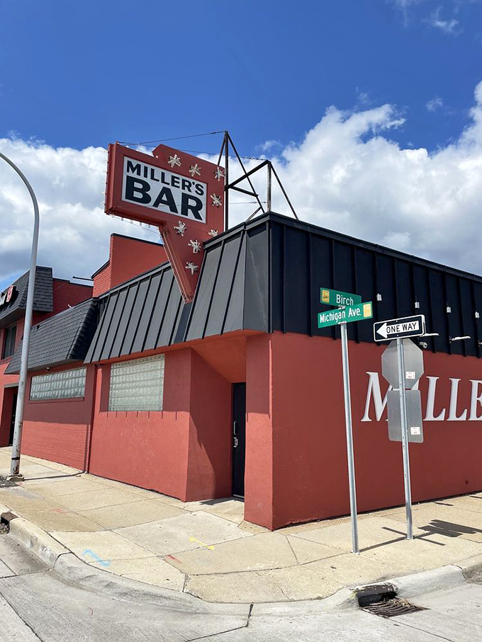 The iconic red sign at Miller's Bar stands like a beacon of burger hope at the corner of Michigan and Birch in Dearborn.