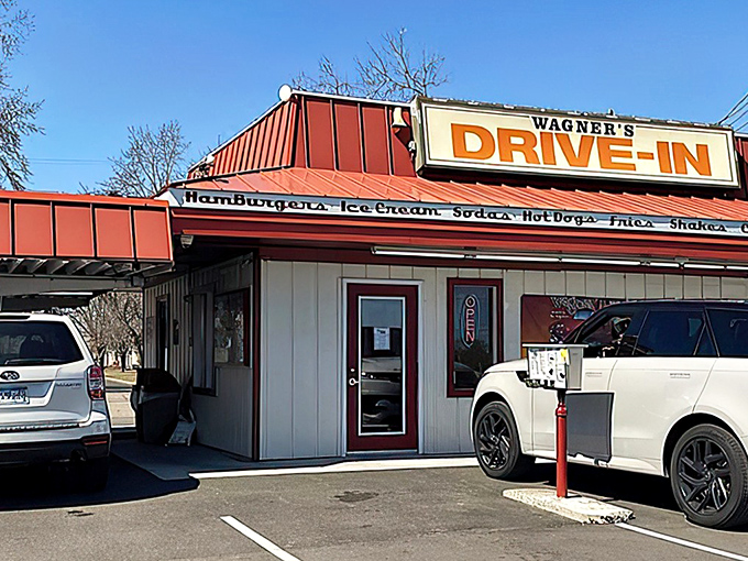 The iconic red-roofed Wagner's Drive-In stands like a time portal to simpler days, beckoning hungry travelers with promises of hand-crafted burgers and nostalgia by the plateful.