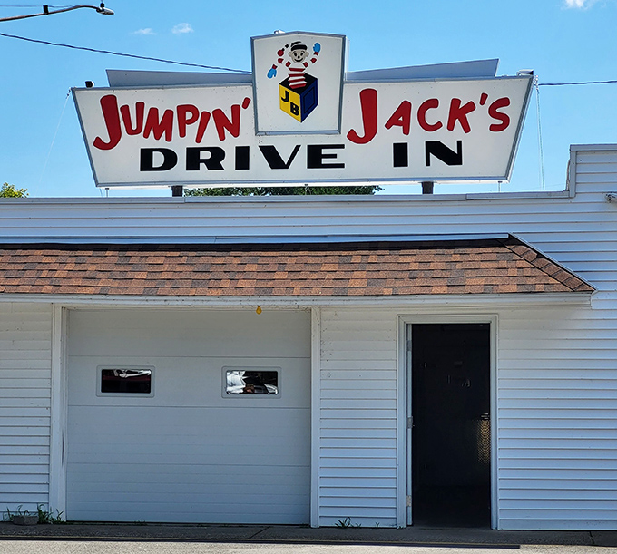 The iconic Jumpin' Jack's sign stands proudly against dramatic skies, while Old Glory waves from a fire truck ladder&mdash;a Scotia summer tradition in full swing.
