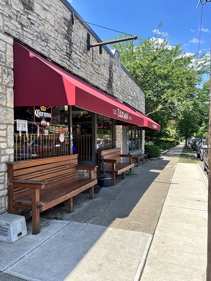 The unassuming stone exterior with its crimson awning doesn't scream "burger legend," but the wooden benches outside hint at something worth waiting for.