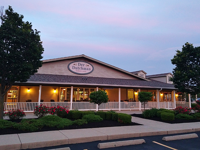 The sunset glow on Der Dutchman's wraparound porch feels like a warm-up act for the comfort food main event waiting inside.