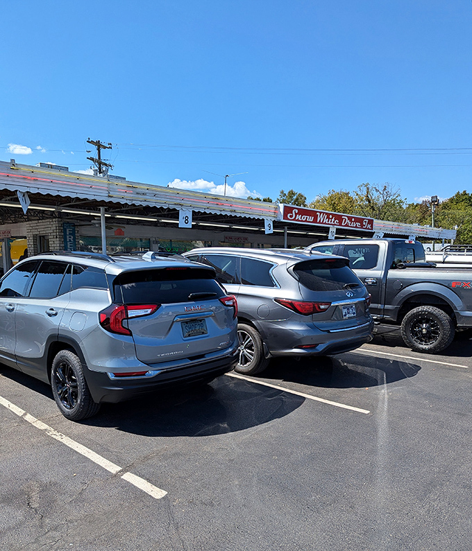 The iconic red sign beckons hungry travelers like a neon lighthouse. Snow White Drive In has been Lebanon's comfort food beacon since the Eisenhower administration.