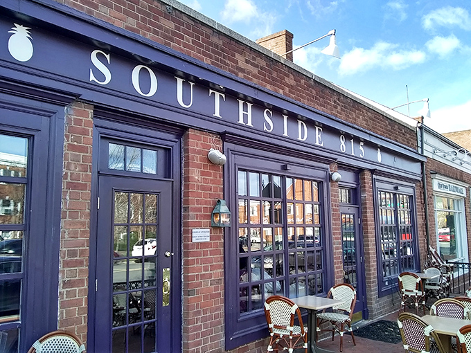 The inviting brick exterior of Southside 815 with its navy blue awning and charming patio seating beckons hungry travelers like a Southern lighthouse. 