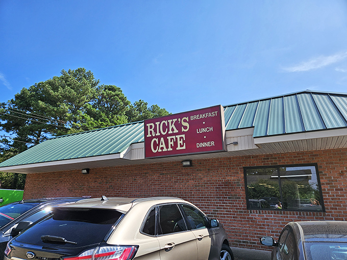The unassuming brick exterior of Rick's Cafe stands like a culinary lighthouse, its green roof and straightforward signage promising honest food without pretense.