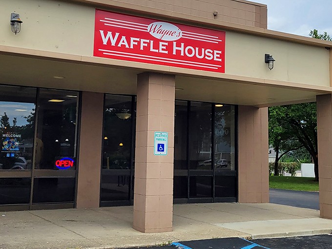 The bright red sign beckons like a lighthouse for the breakfast-starved. Wayne's Waffle House stands ready to fulfill your deepest carb fantasies. 