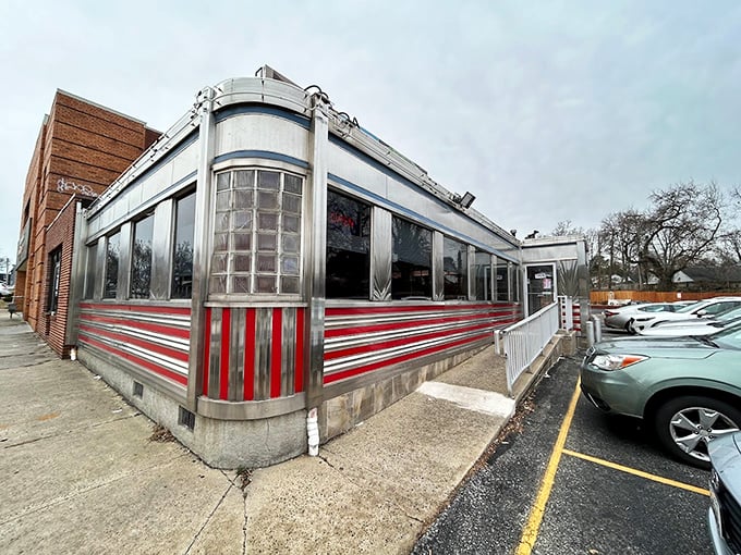 The gleaming stainless steel exterior of Overlea Diner stands like a time machine to the golden age of American dining, complete with those iconic red stripes.