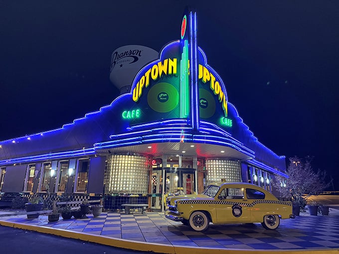 The neon-drenched facade of Jackie B. Goode's glows like a beacon of nostalgia, complete with a vintage yellow taxi that seems to have time-traveled straight from the 1950s.