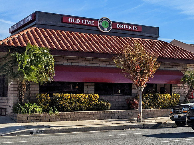 The red-tiled roof and brick facade of Old Time Drive In stands as a beacon of comfort food in Sun Valley, where California sunshine meets classic American dining.