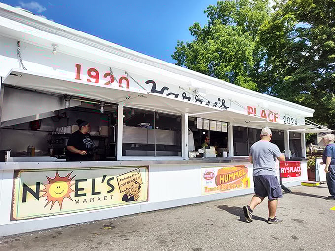 The white facade of Harry's Place stands like a culinary lighthouse, beckoning hungry travelers with its iconic red lettering and promise of roadside bliss.