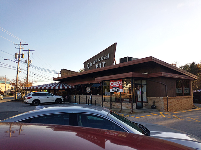 The iconic A-frame roof of Charcoal Pit stands like a mid-century beacon on Concord Pike, promising burger bliss to all who enter.