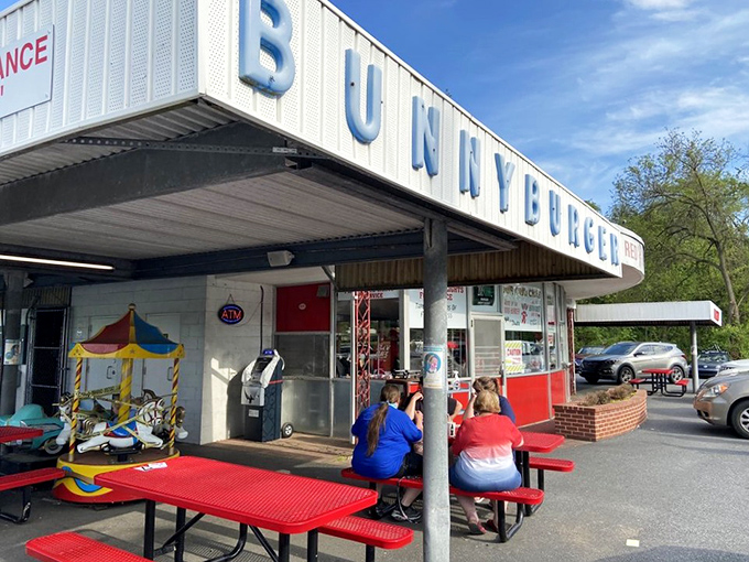The iconic "Make The Red Rabbit A Habit" sign welcomes hungry travelers like a beacon of burger salvation on Route 322. Nostalgia never tasted so good.