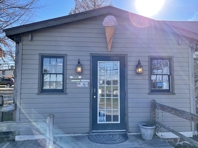 The farmhouse charm of Woodside Farm Creamery beckons like an ice cream siren, with its stone wall and iconic cone sign promising dairy delights within.