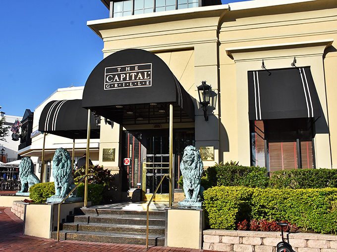 The iconic blue-canopied entrance guarded by regal lion statues promises an experience that's anything but ordinary. This is your gateway to carnivorous bliss.