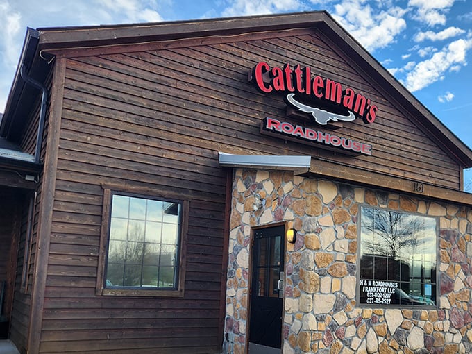 The rustic wooden exterior of Cattleman's Roadhouse beckons like an old friend, promising comfort and satisfaction within those stone-accented walls.